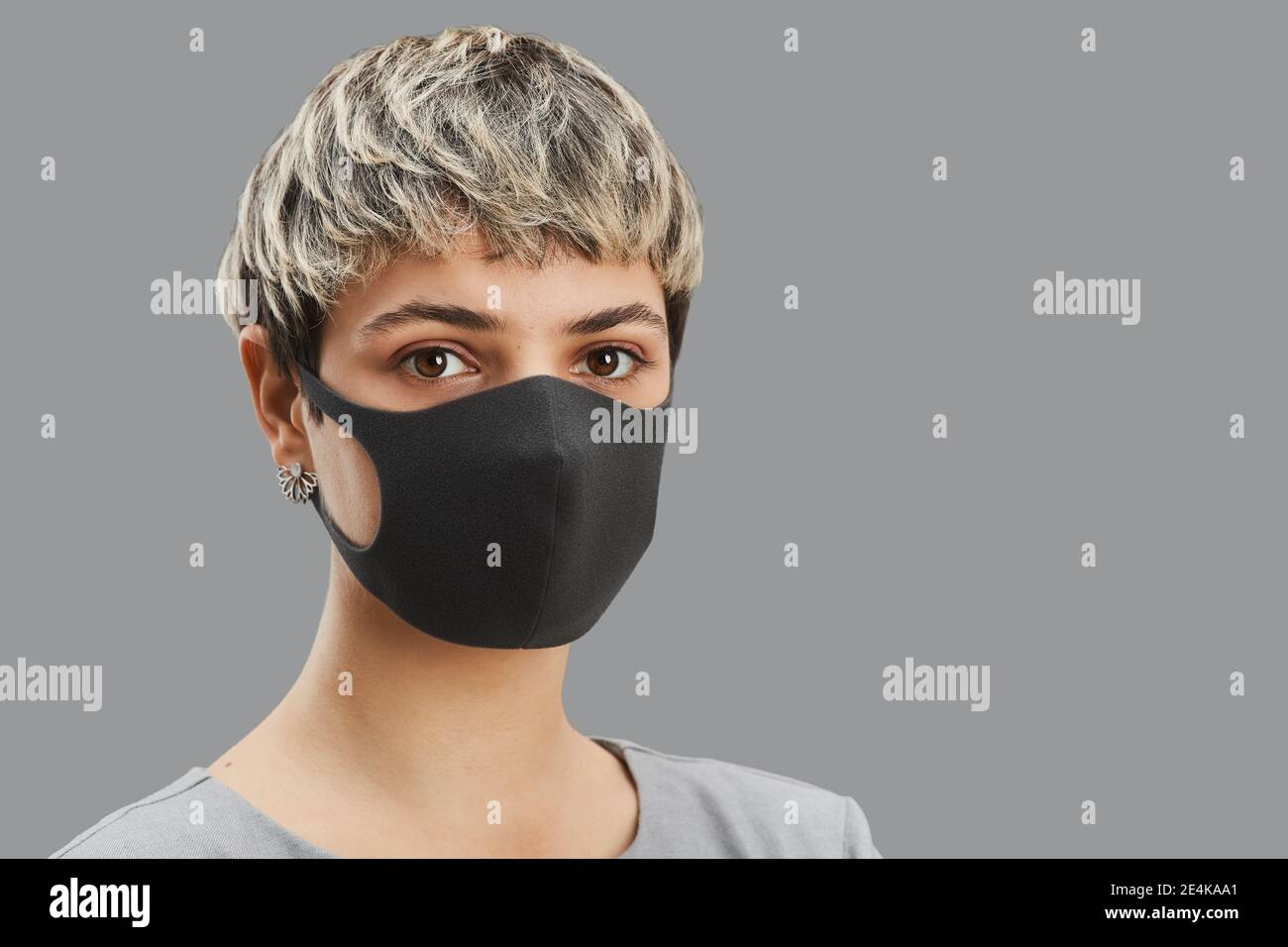 Head and shoulders portrait of contemporary short-haired woman wearing ...