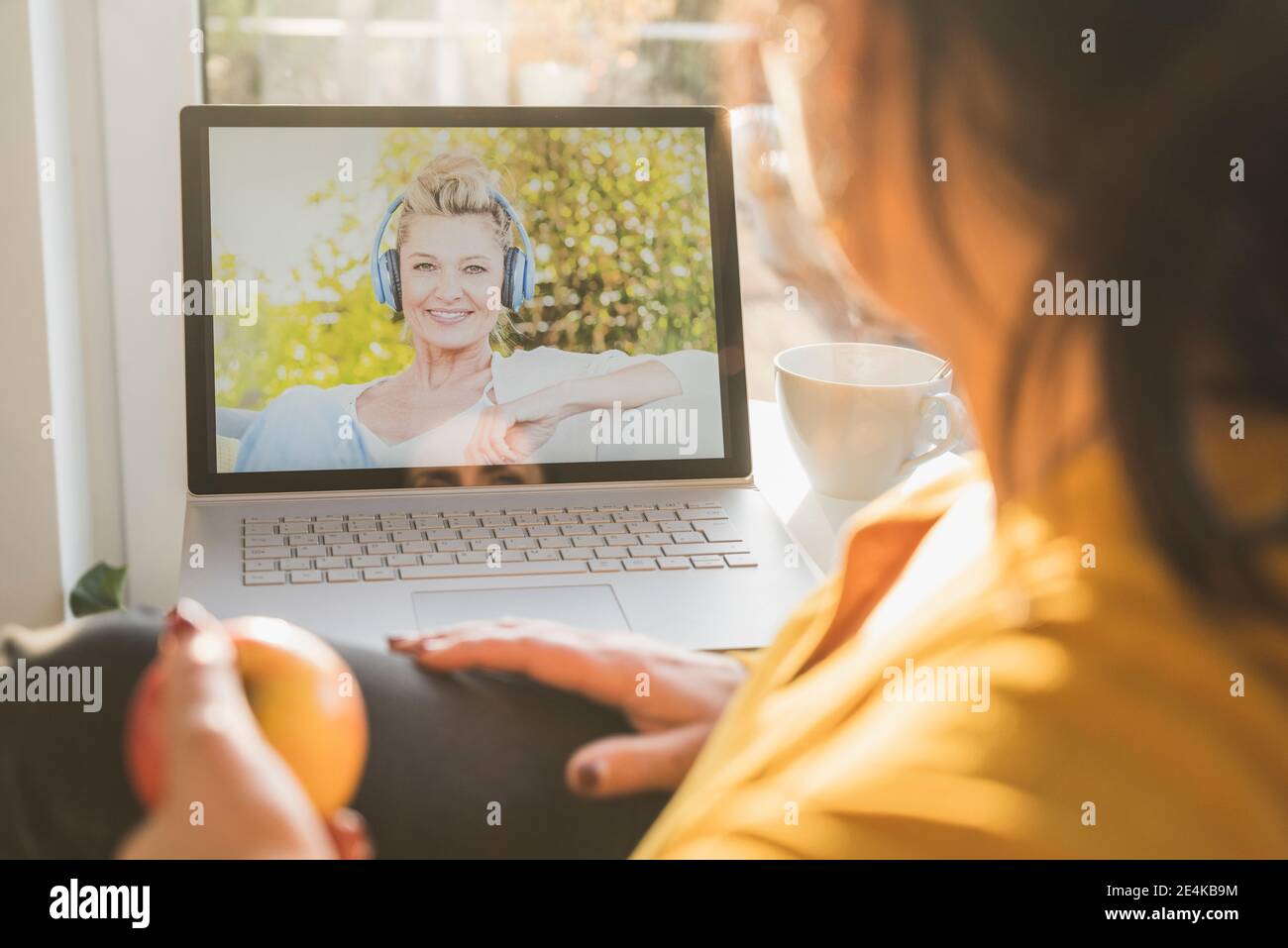 Two women talking during video call on laptop Stock Photo - Alamy