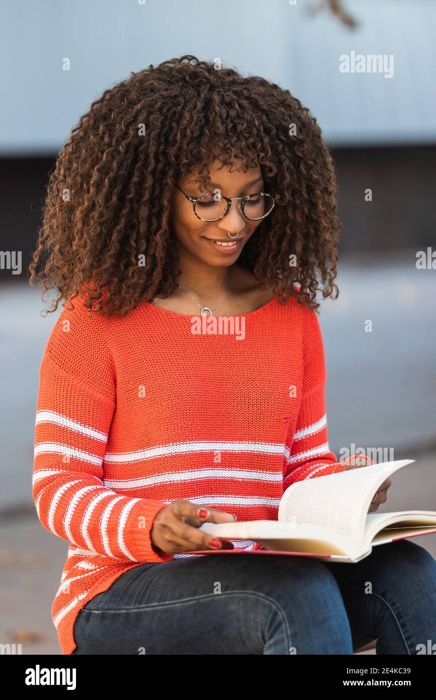 Woman in red sweater glasses hi-res stock photography and images - Alamy