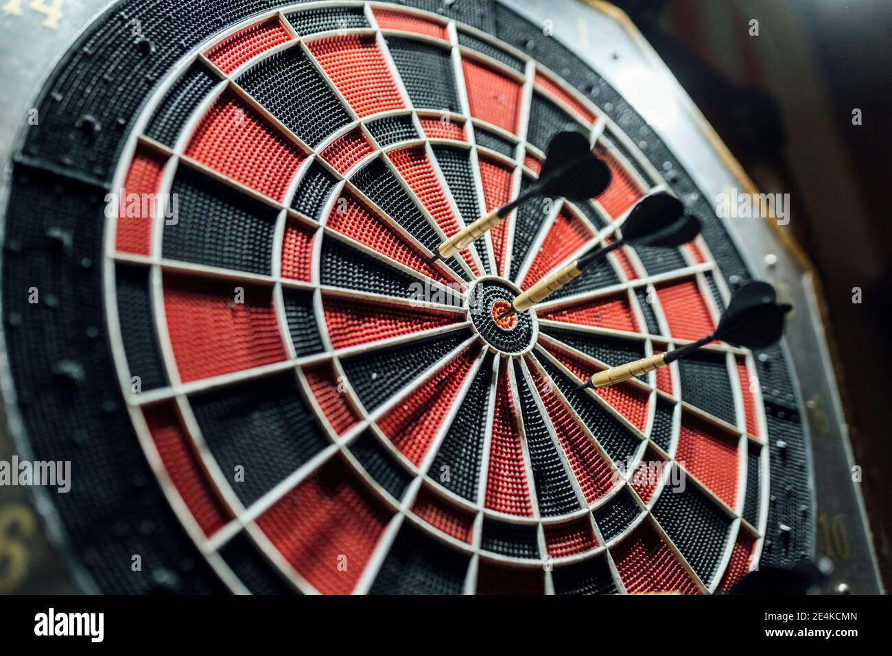 Black and red dartboard with darts Stock Photo - Alamy