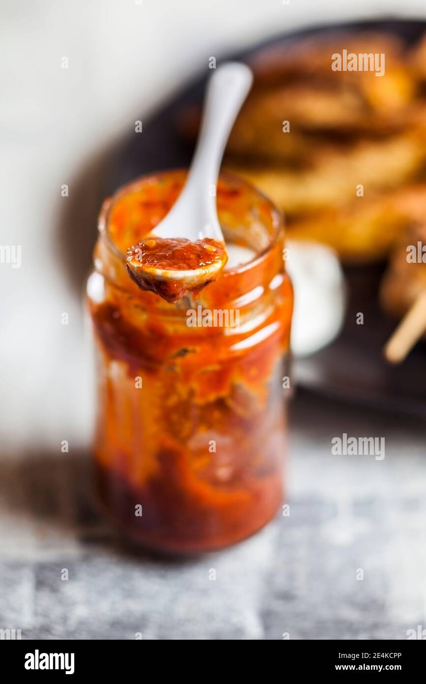 Homemade red chili sauce jar on table Stock Photo - Alamy