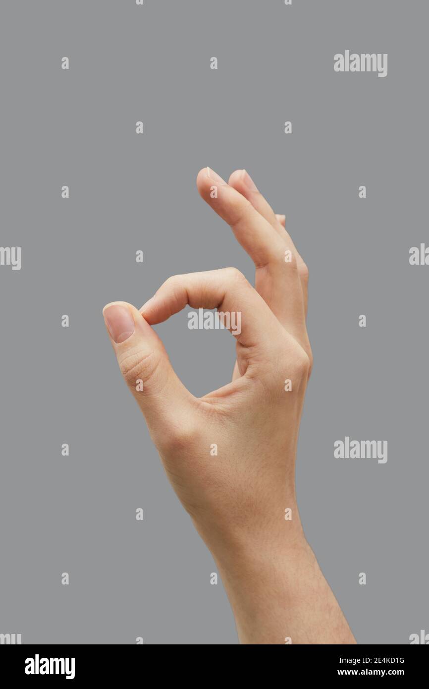 Minimal graphic image of female hand showing OK sign against gray ...
