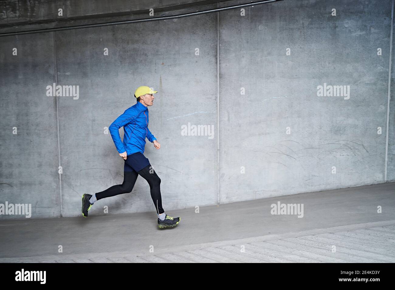 Mature man jogging in parking garage of residential building Stock ...