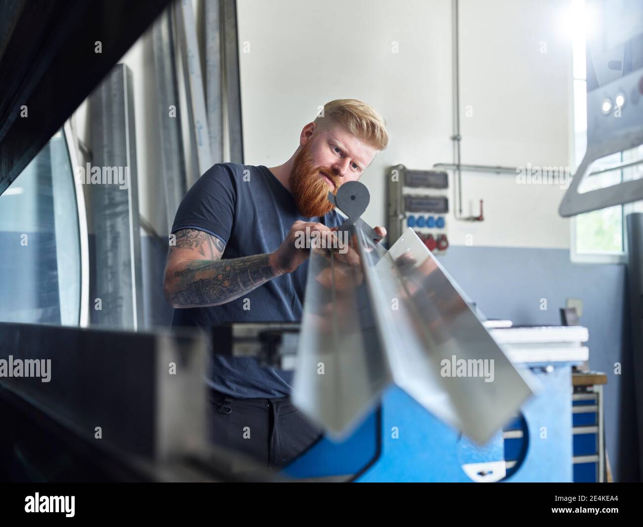 Inspector checking material while working at factory Stock Photo - Alamy