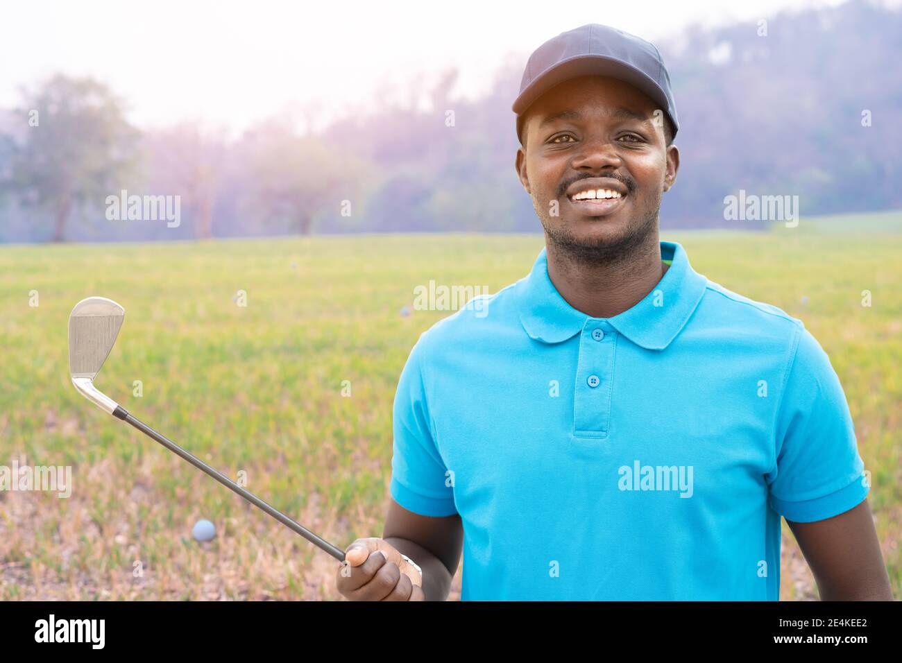 African golfer standing in golf course Stock Photo - Alamy