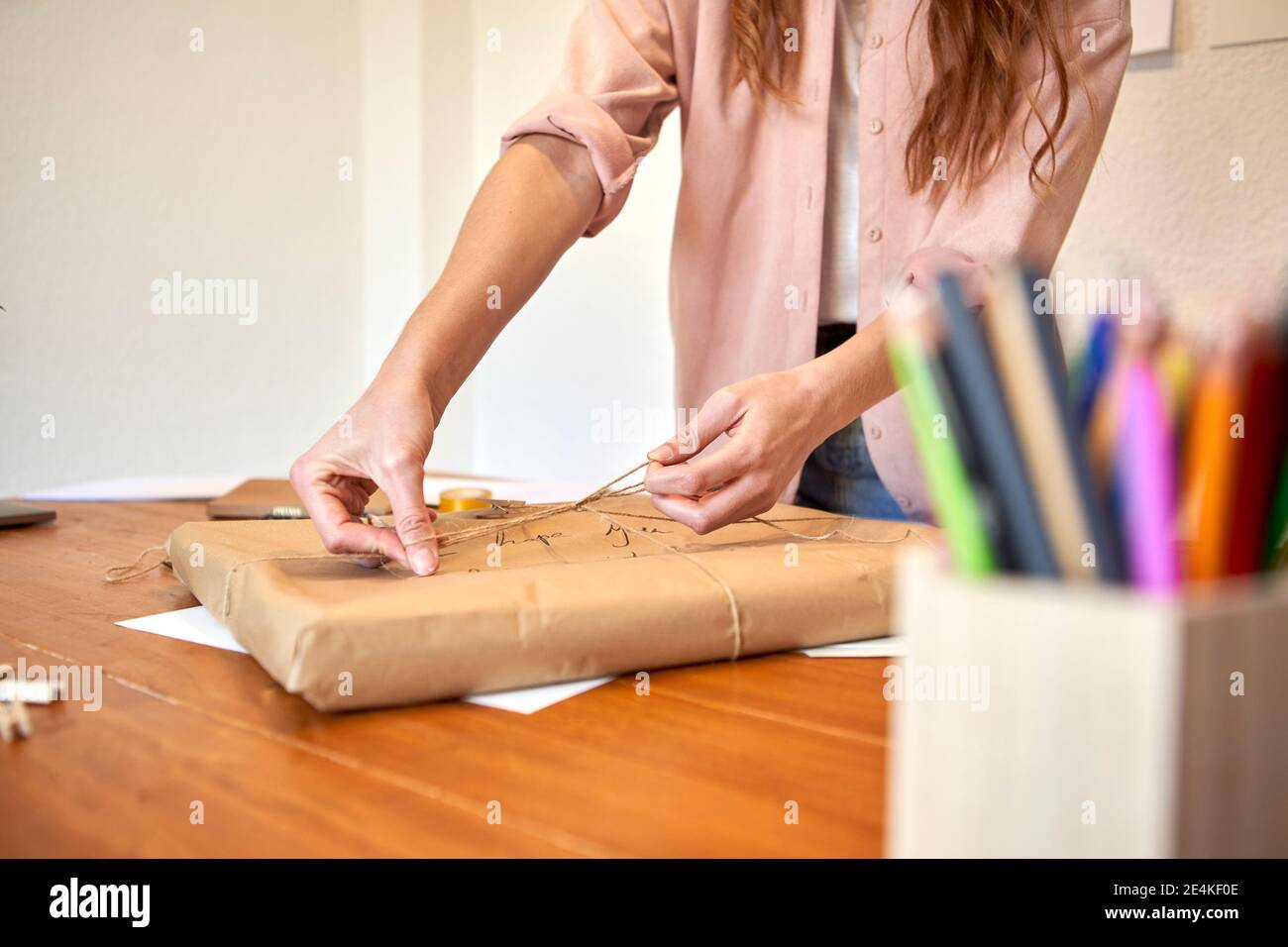 Woman tying knot string hi-res stock photography and images - Alamy