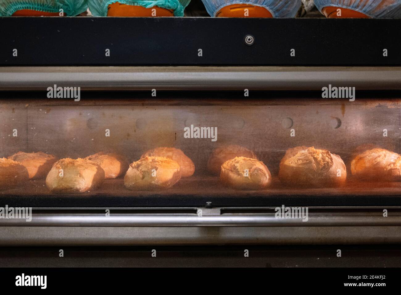 Breads getting baked in oven at bakery Stock Photo - Alamy