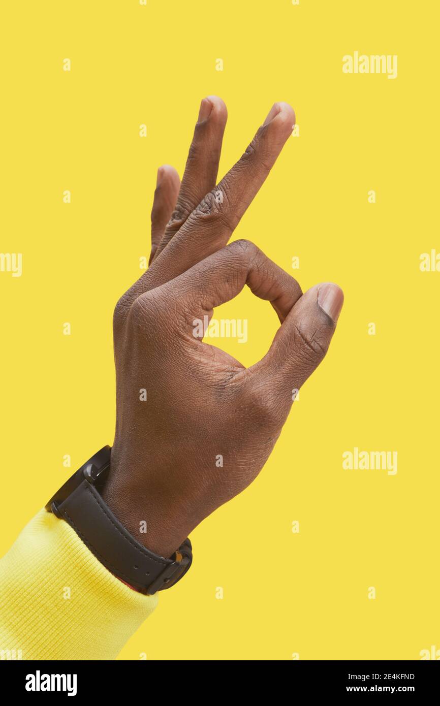 Graphic close up of African-American male hand showing OK sign against ...