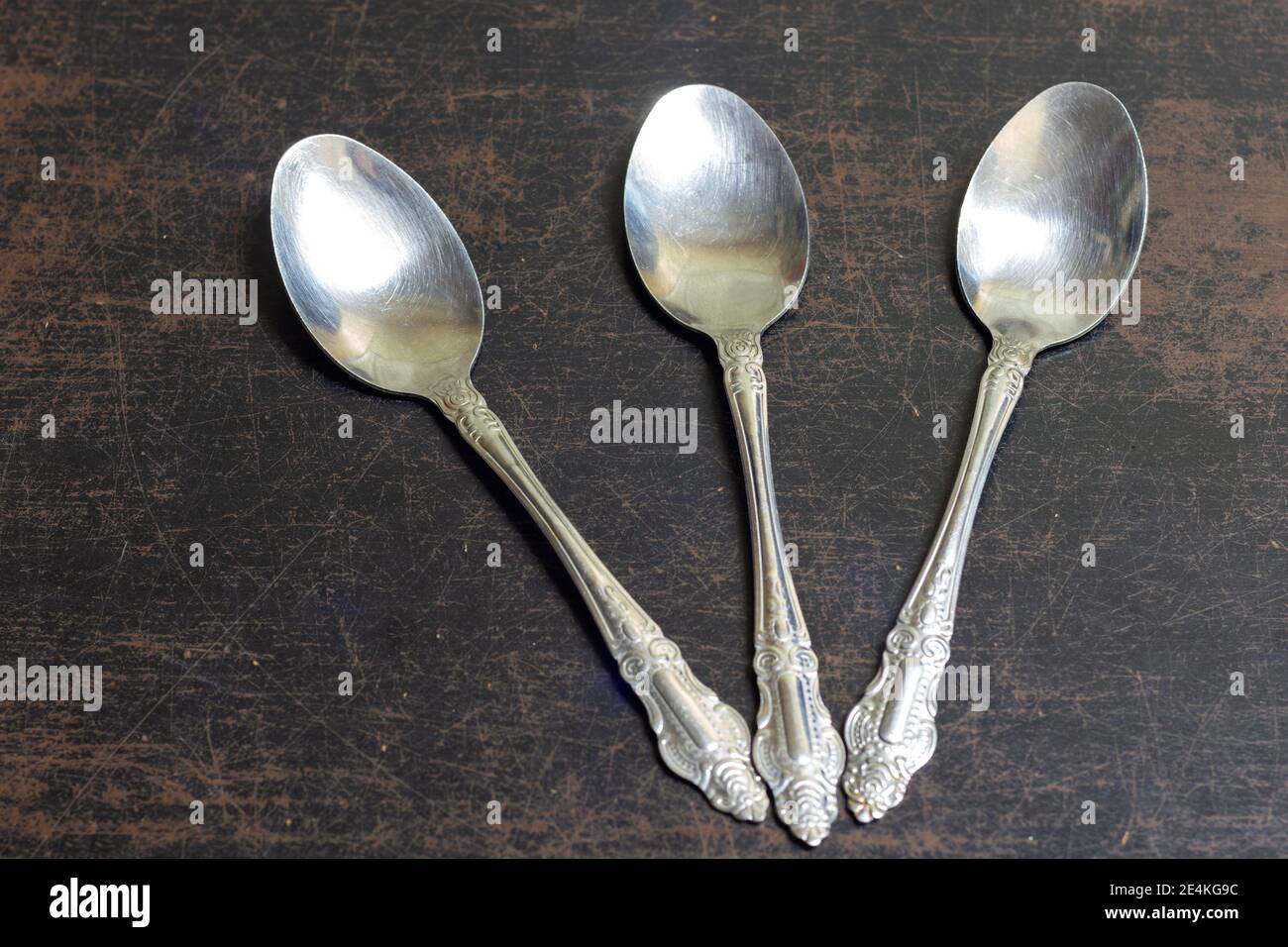 There are three tablespoons on the old table Stock Photo - Alamy