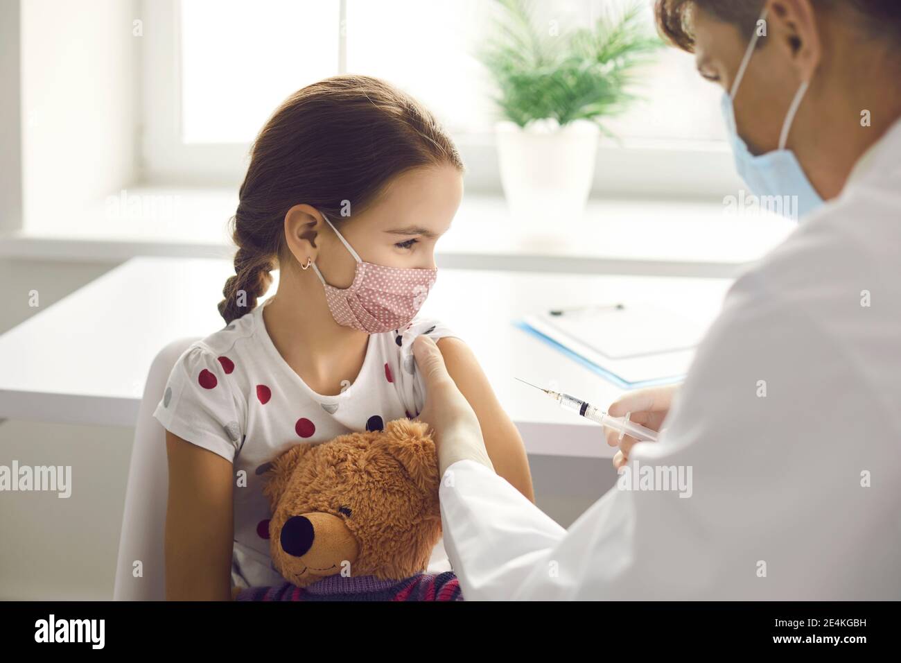 Girl getting a shot by a nurse hi-res stock photography and images - Alamy