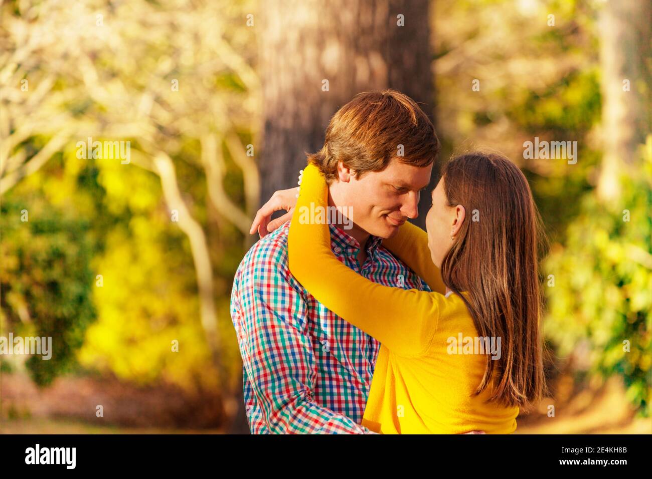 Close portrait of a young adults lovely couple hug outside in the park ...