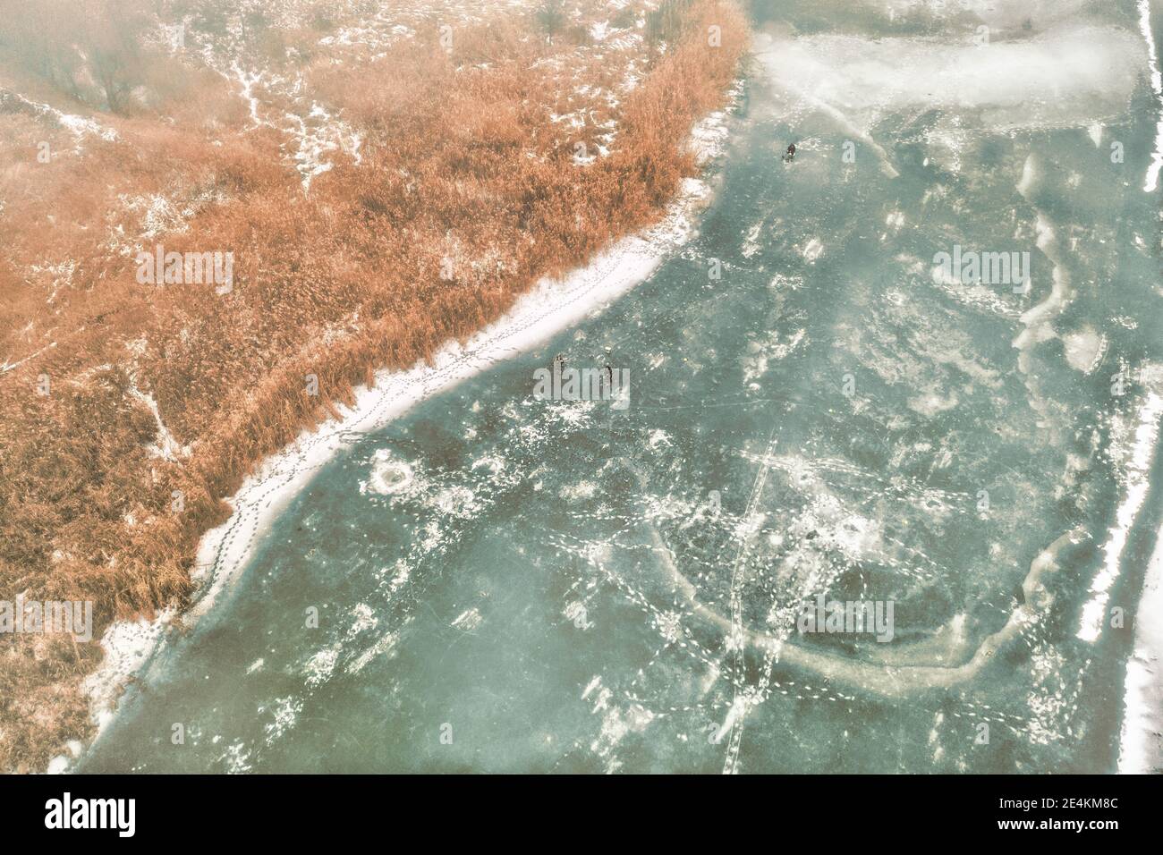 Frozen surface of the river with ice during winter fishing. The texture ...