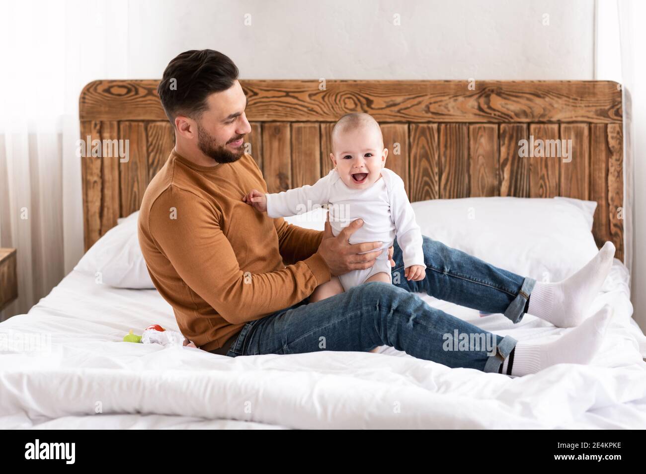 Young Father And Little Baby Bonding And Playing Sitting Indoors Stock ...