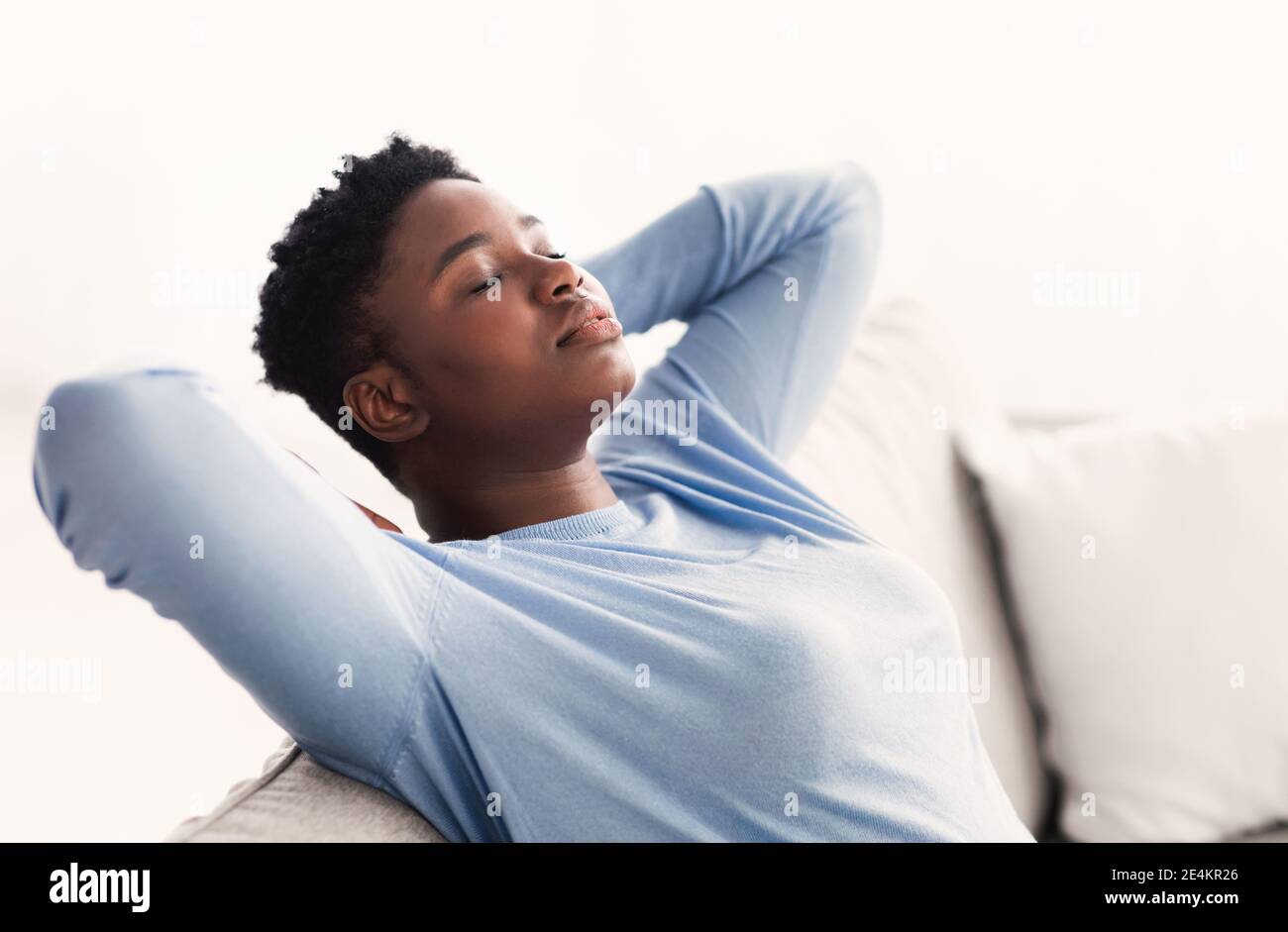 Black woman having rest at home on the sofa Stock Photo - Alamy