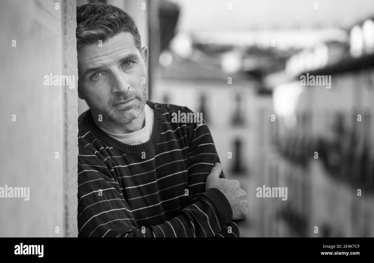 dramatic artistic portrait of attractive man sad and depressed at home ...