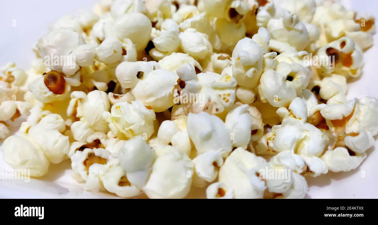 Heap of delicious popcorn, isolated on white background. Scattered ...