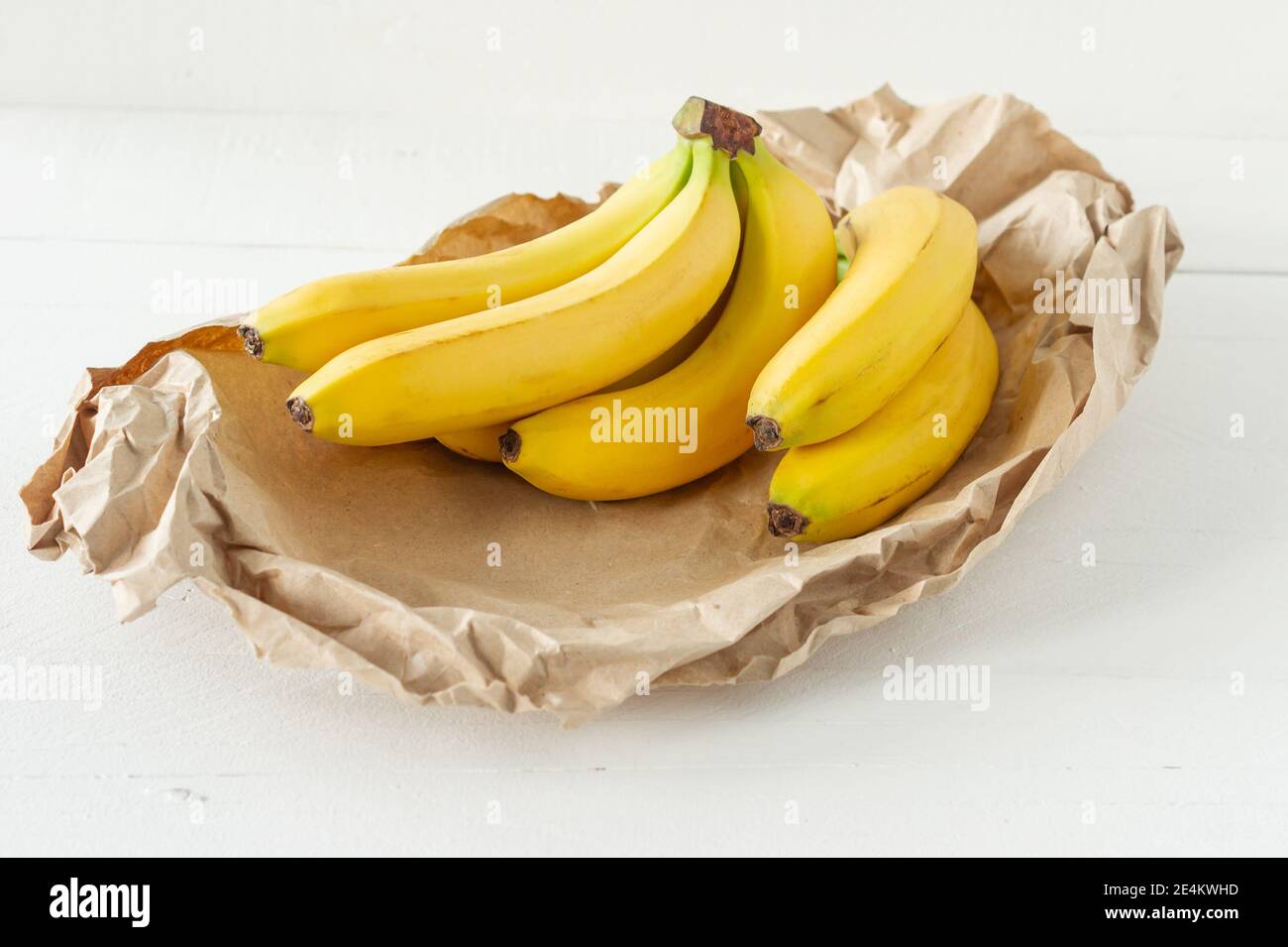 Ripe bunch of bananas in paper bag. Healthy eating concept Stock Photo ...