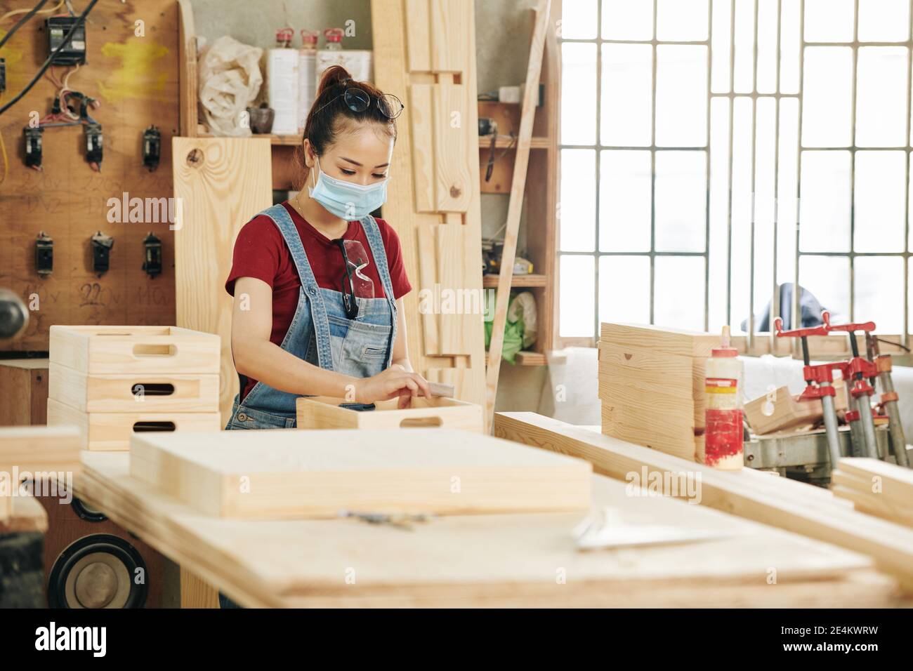 Female carpenter polishing drawer Stock Photo - Alamy
