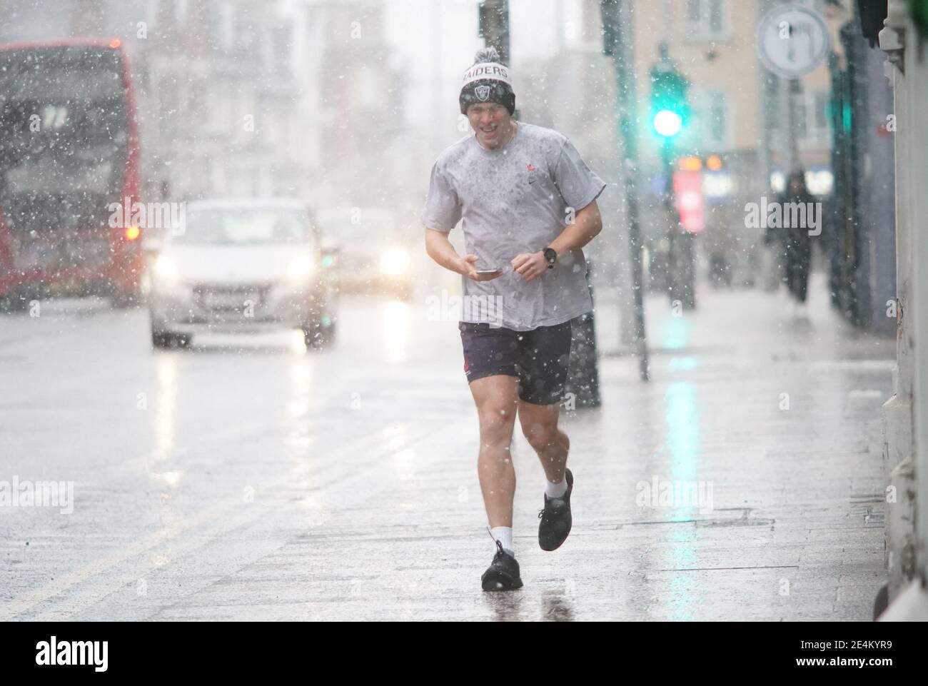 A man running in snow in Clapham, London. Picture date: Sunday January ...