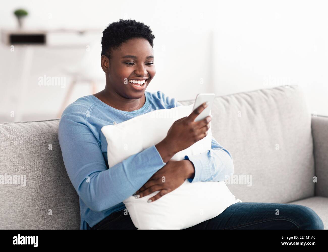 African woman hugging pillow hi-res stock photography and images - Alamy