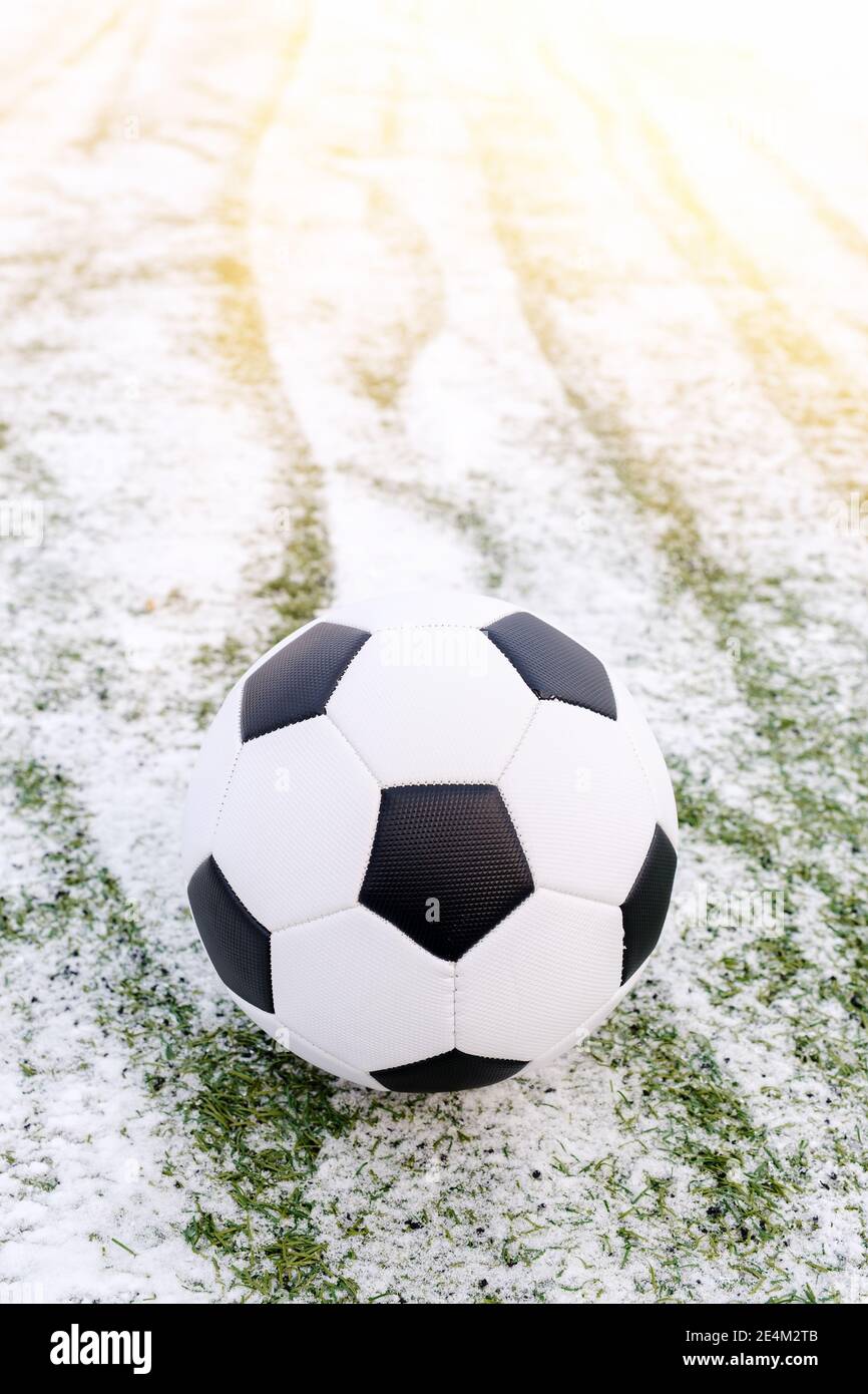 Football ball on snowy grass in winter Stock Photo - Alamy