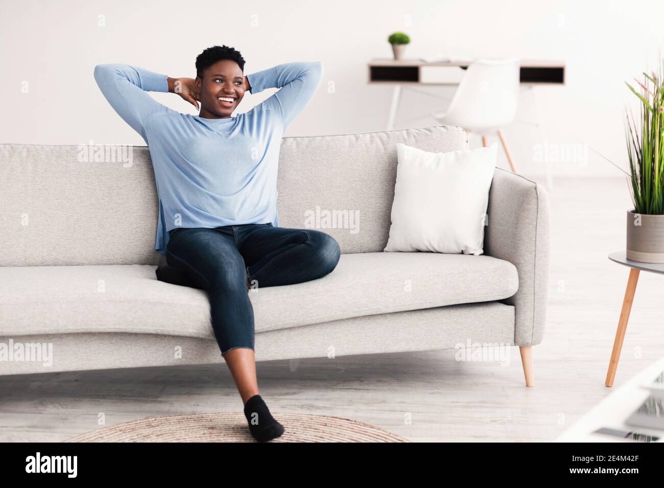 Black woman having rest at home on the couch Stock Photo - Alamy