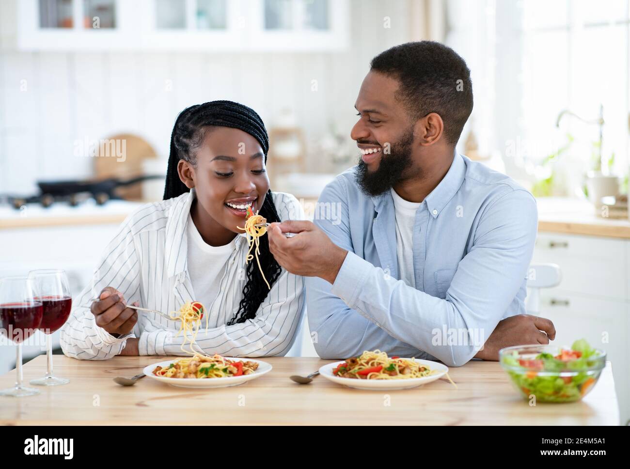 Beautiful african american couple having romantic lunch together in ...