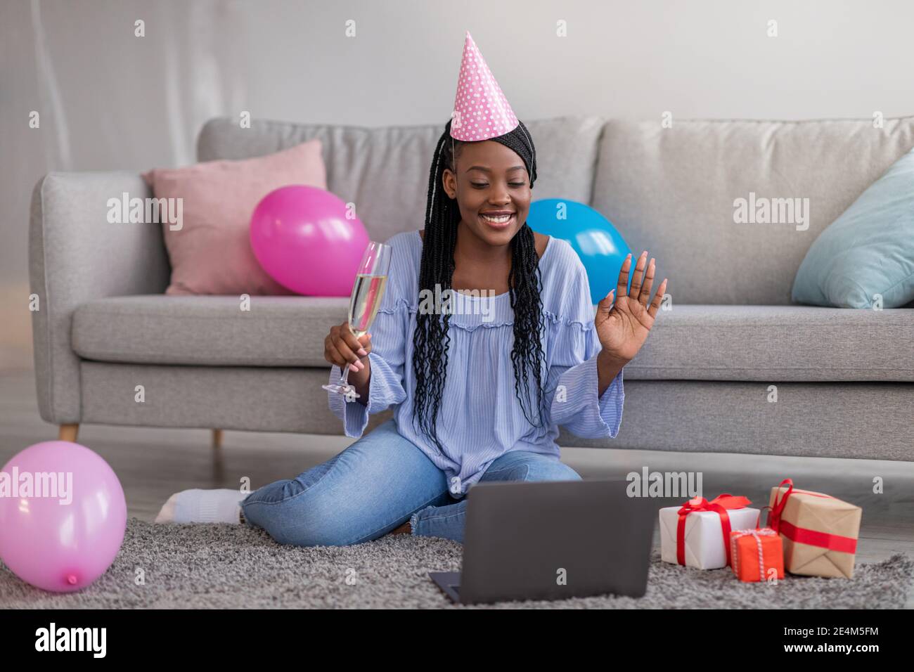 Happy african lady with glass of champagne having online party Stock ...