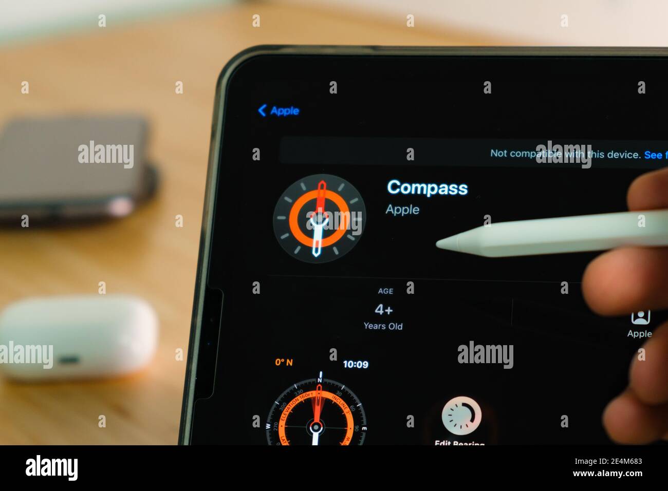Compass logo shown by apple pencil on the iPad Pro tablet screen. Man ...