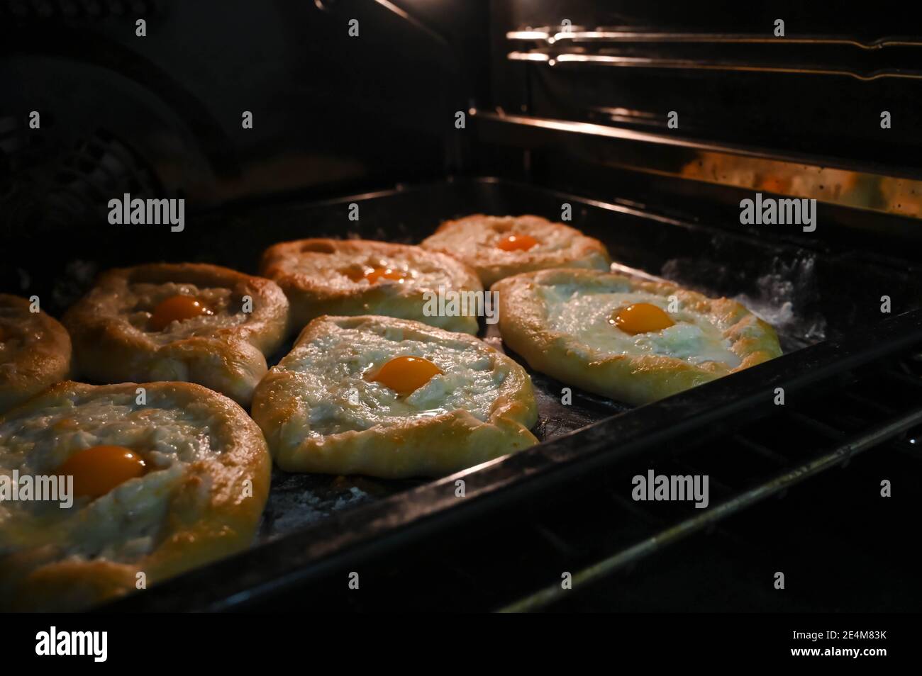 Close-up of baking khachapuri on tray in oven Stock Photo - Alamy