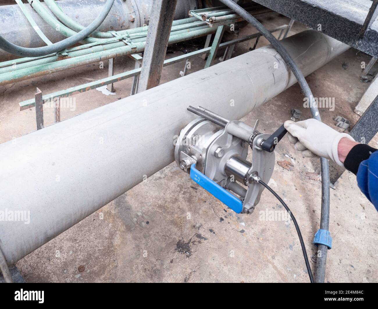 Closing the chemical pipeline output. The worker closes the ball valve ...