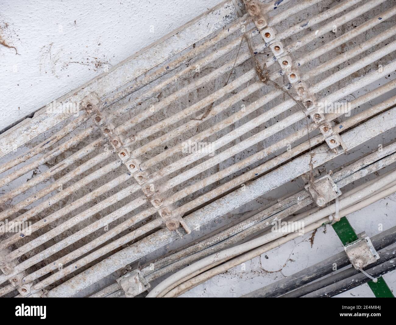 Electric cables. Old wires on the wall in underground shaft under dust ...