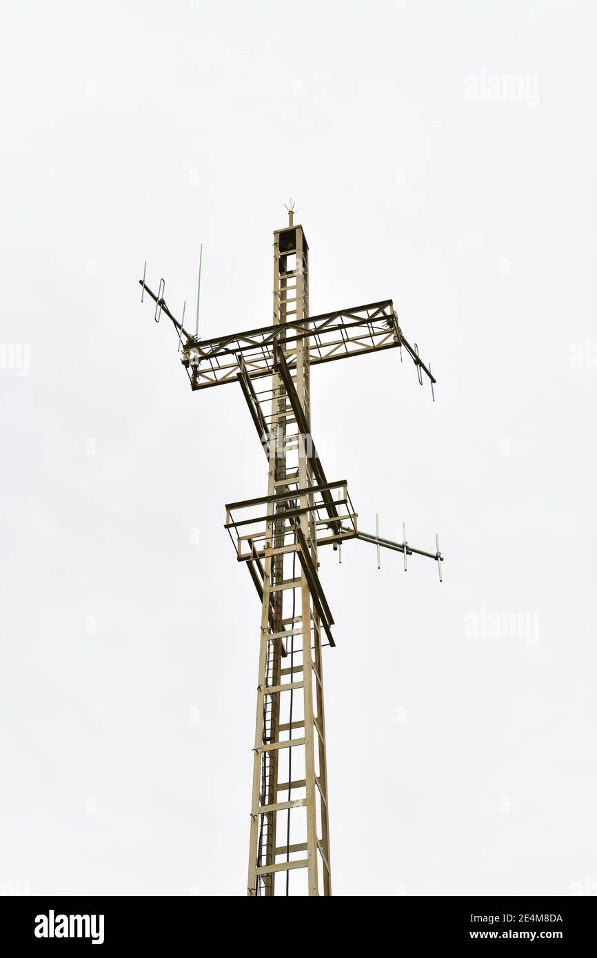 A low angle of a high voltage electric post isolated on white ...