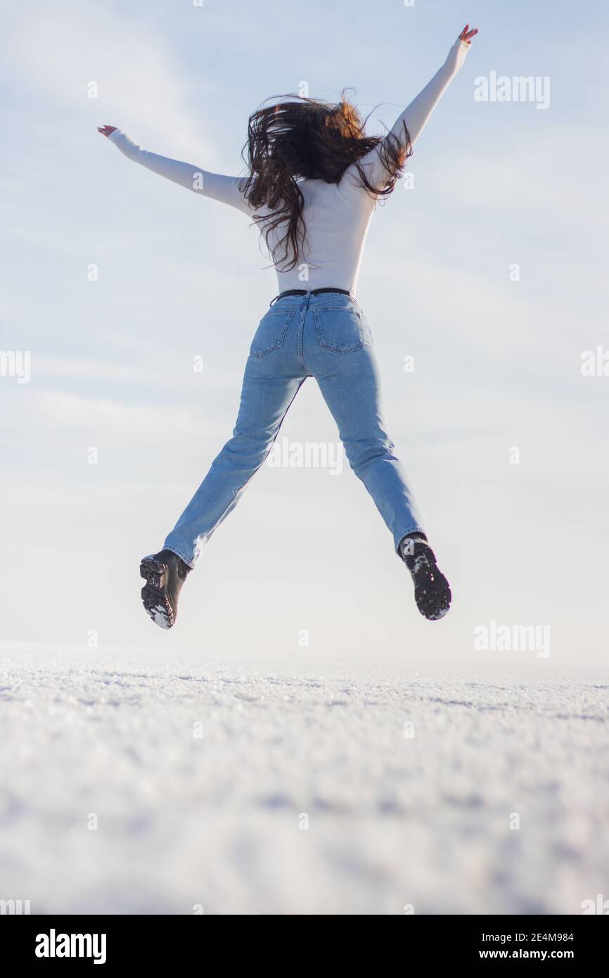 Young woman jumping happily hi-res stock photography and images - Alamy
