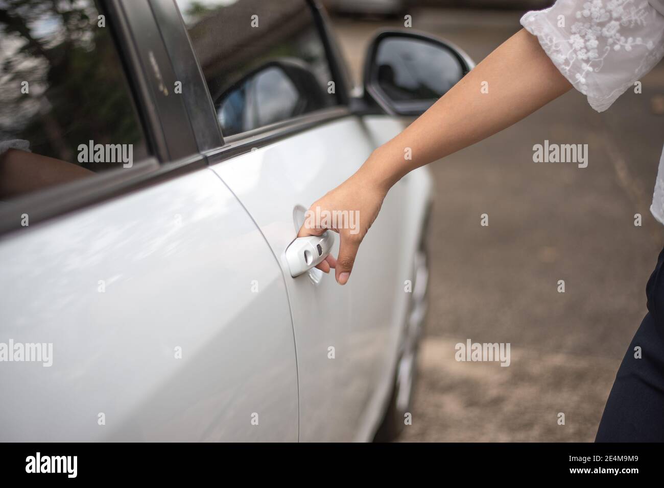 Woman Holding Handle Car Door Stock Photo - Alamy