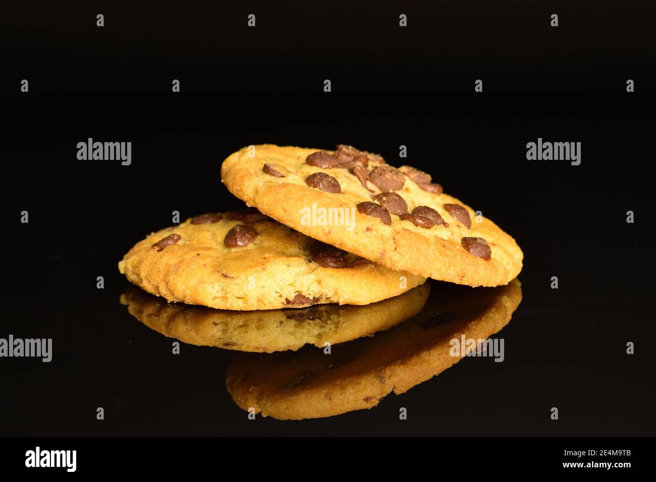 Two whole round, fragrant delicious fresh cookies with pieces of milk ...