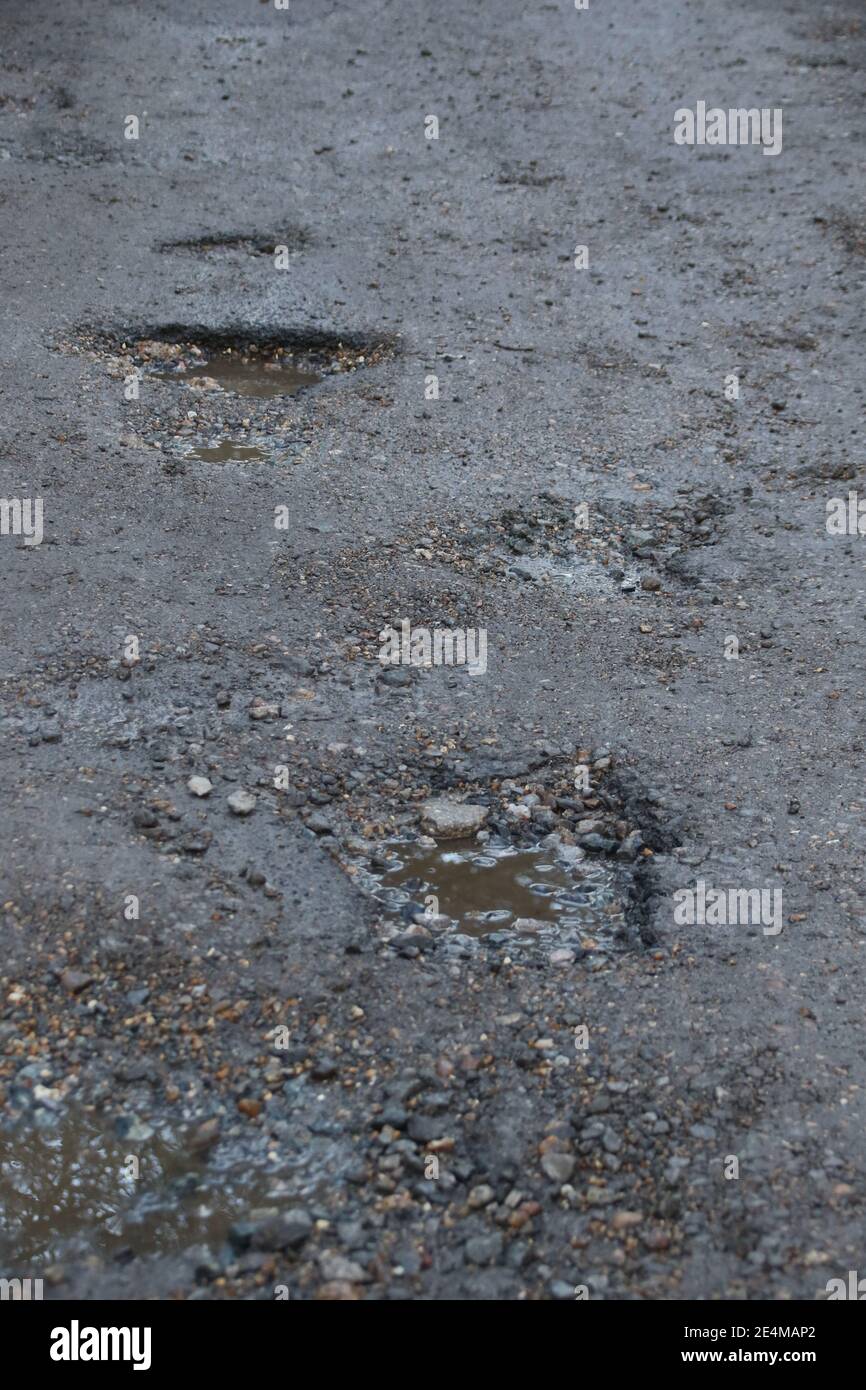 potholes in a road Stock Photo - Alamy