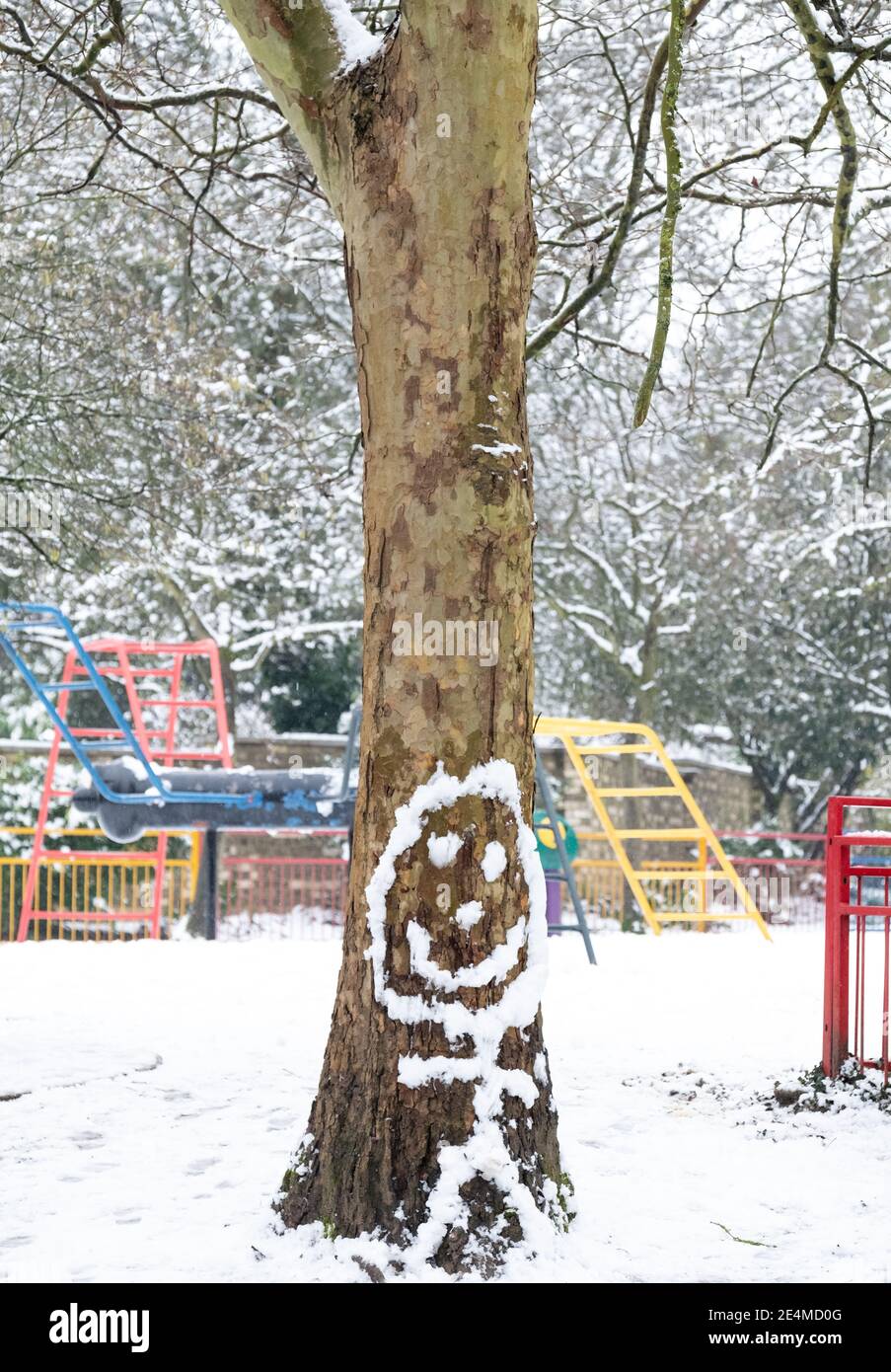 Outline of a smiling face snowman on a tree in the playground area at ...