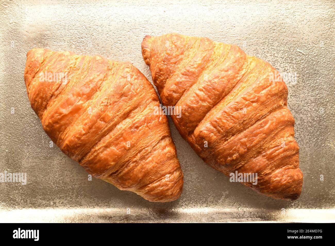 Two fragrant sweet croissants on a metal tray, top view, close-up Stock ...