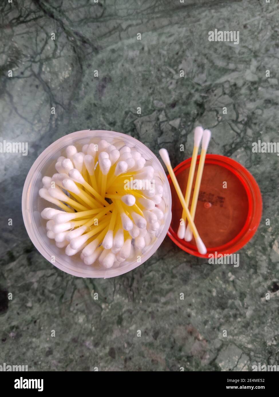 A vertical shot of white cotton buds for cleaning ears inside the box ...