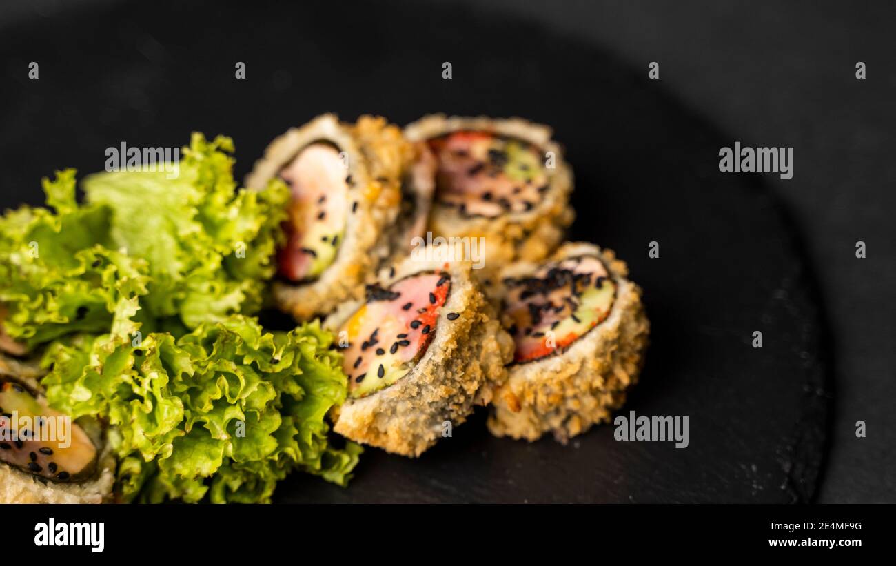 Custom sushi roll in tempura with nori, fresh salmon, tuna, avocado ...