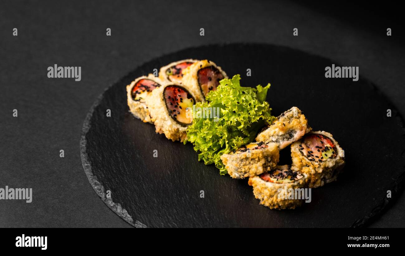 Custom sushi roll in tempura with nori, fresh salmon, tuna, avocado ...