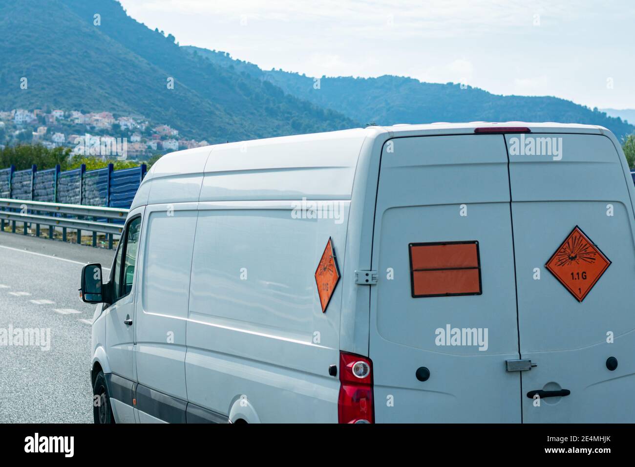 Van transporting explosives, with orange panel and danger labels for ...