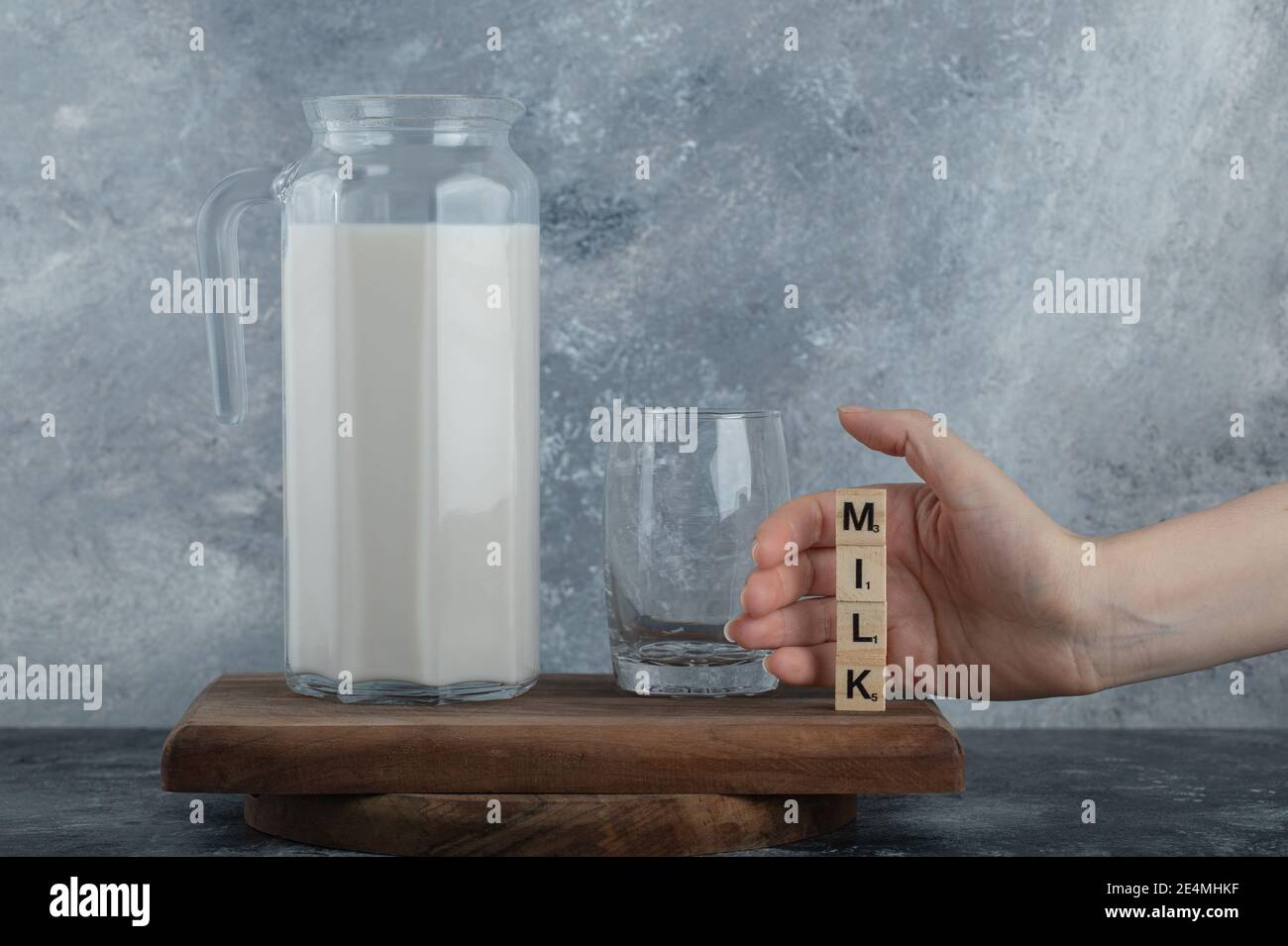 Female hands holding wooden letters with fresh milk Stock Photo - Alamy