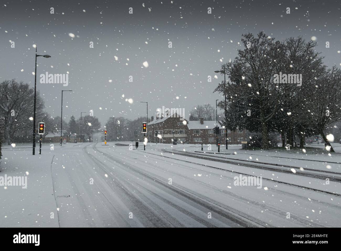 Empty snowy street and crossroad during snowfall in Sutton Coldfield ...