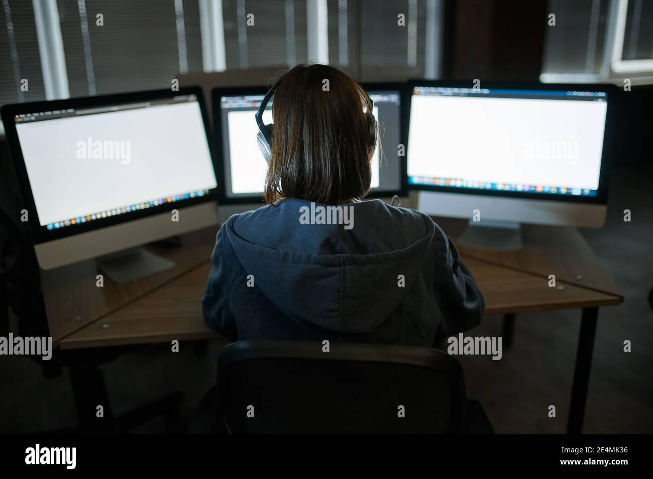 Female hacker in headphones works on computer Stock Photo - Alamy