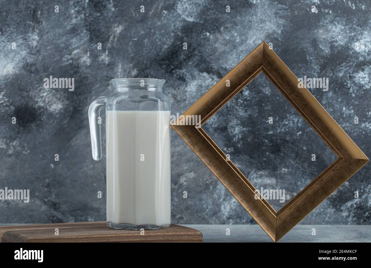 Jug of fresh milk and picture frame on marble background Stock Photo ...
