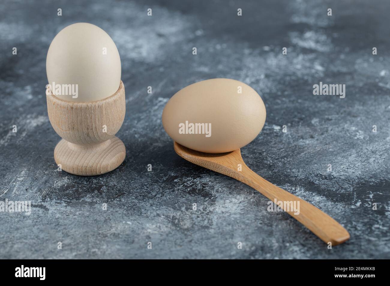 Boiled eggs and wooden spoon on marble background Stock Photo - Alamy