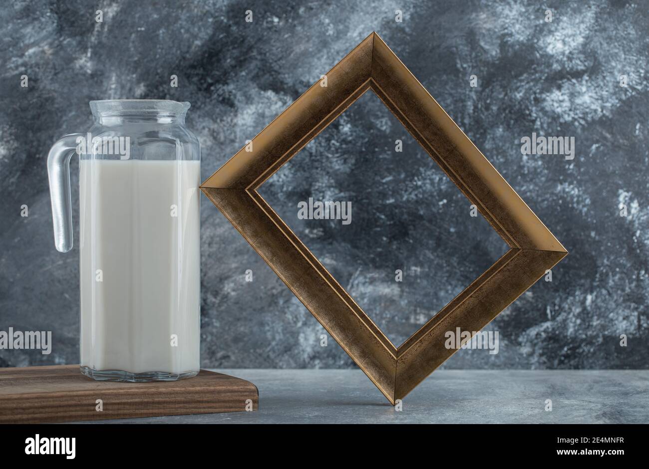 Jug of fresh milk and picture frame on marble background Stock Photo ...