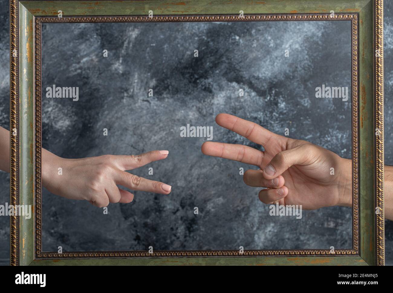 Male and female hands giving signs in middle of picture frame Stock ...